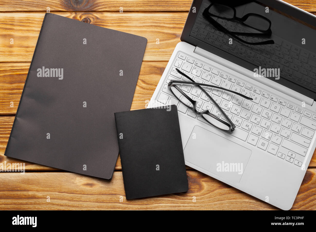 Laptop, notebook on work wooden desk Stock Photo - Alamy