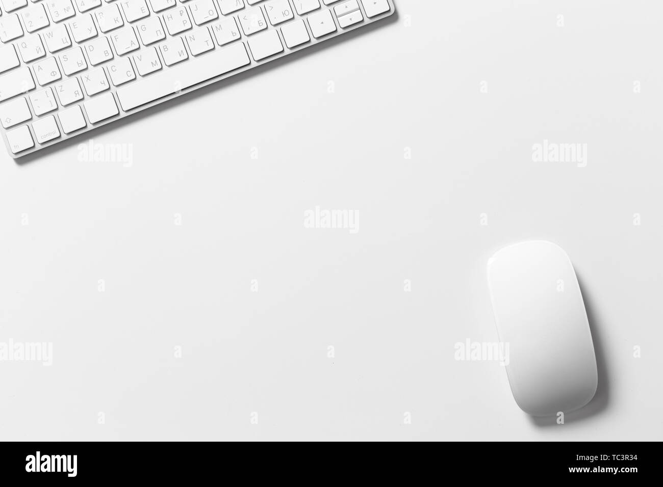 Computer keyboard and mouse on top of white desktop Stock Photo - Alamy
