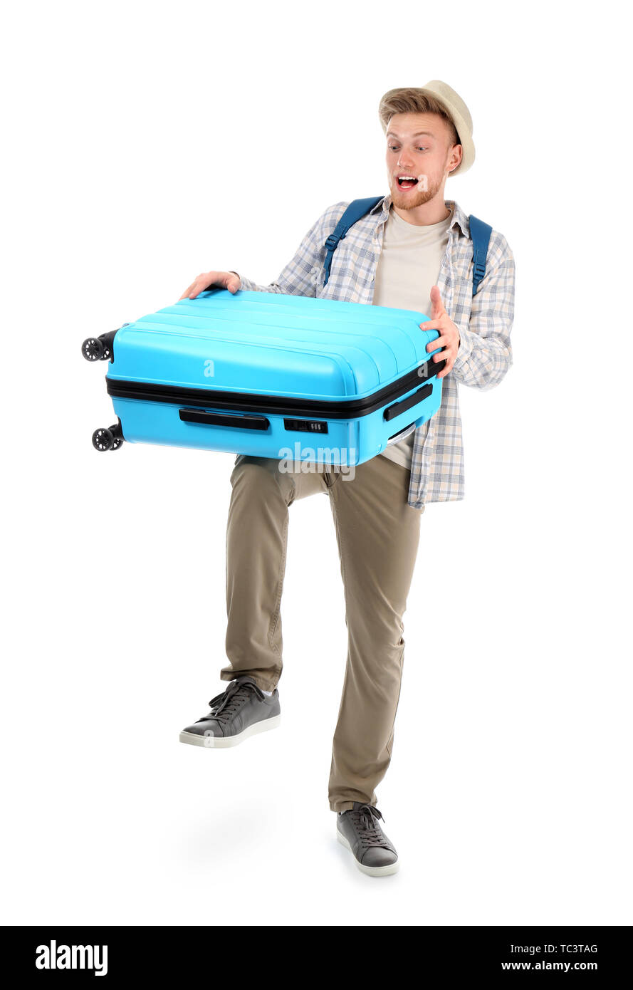 Emotional young tourist with heavy luggage on white background Stock ...