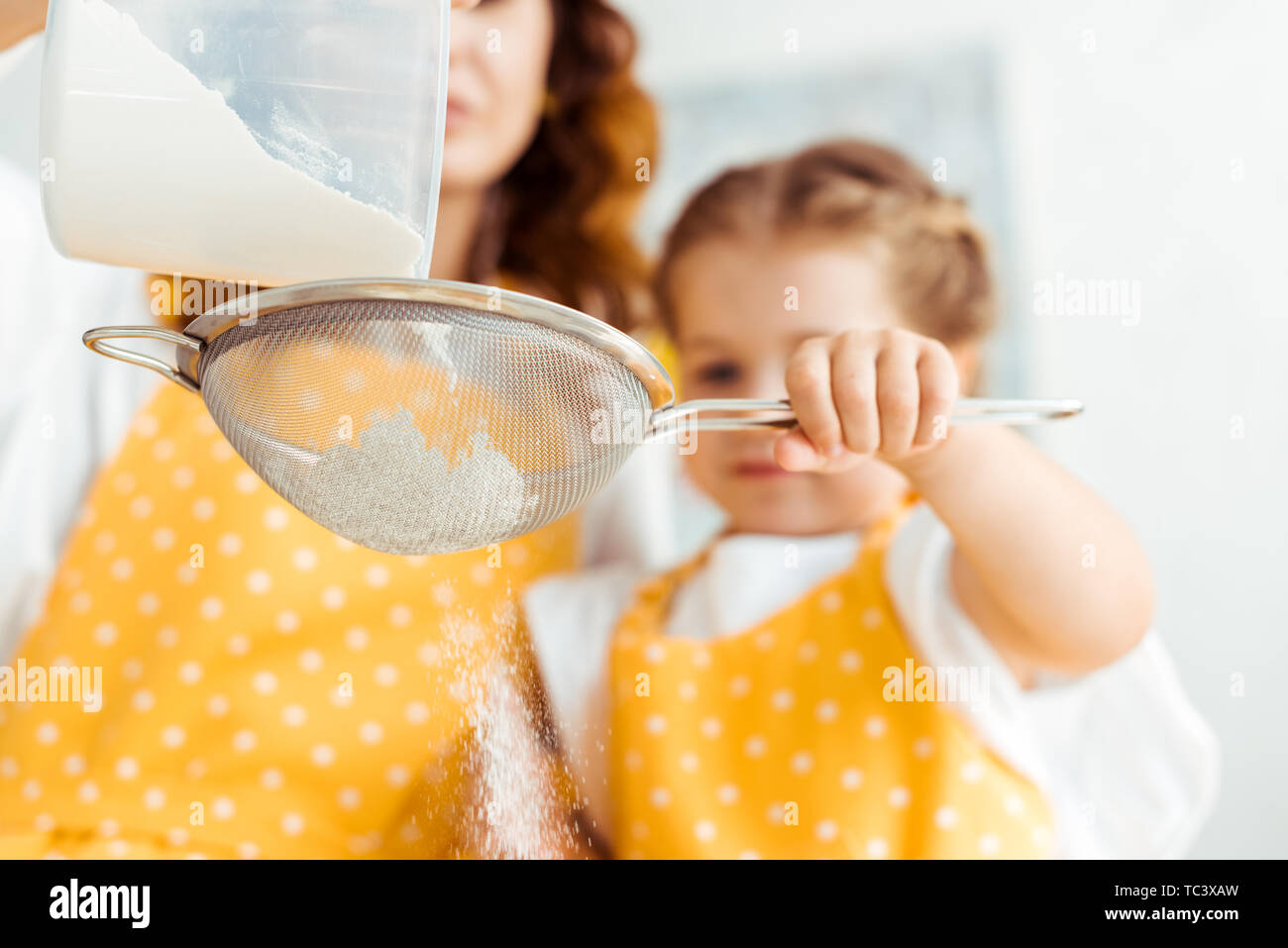 Child sieving flour hi-res stock photography and images - Alamy