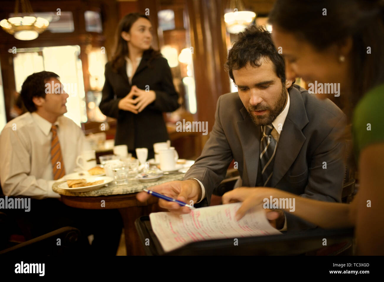 View of people at work while dining Stock Photo - Alamy