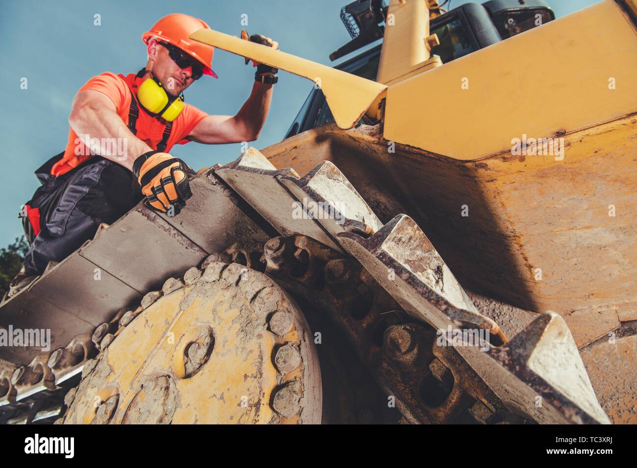 Caucasian Heavy Equipment Mechanic on a Bulldozer. Construction Site ...