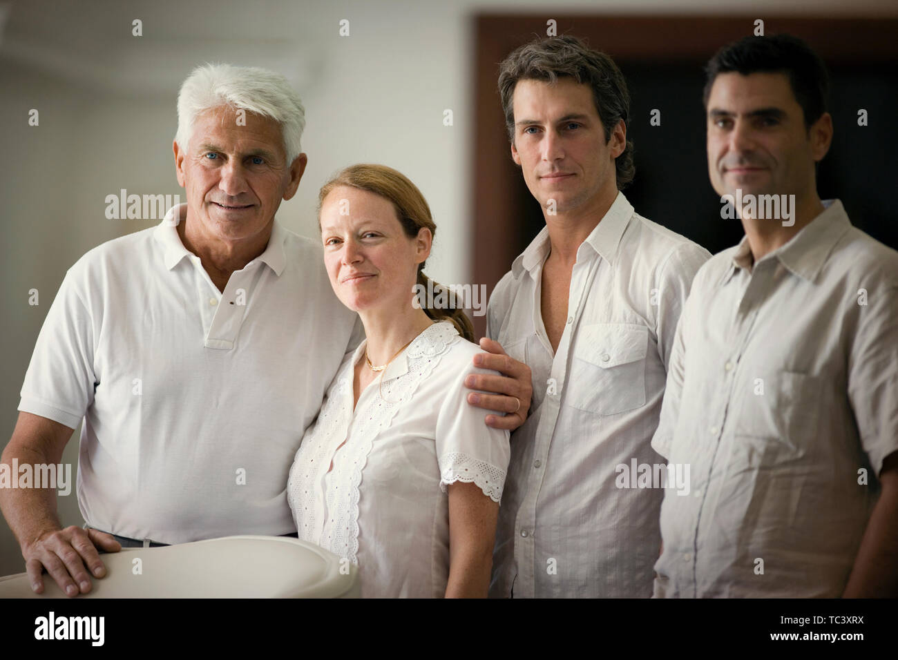 Front view of four people posing for the camera Stock Photo - Alamy
