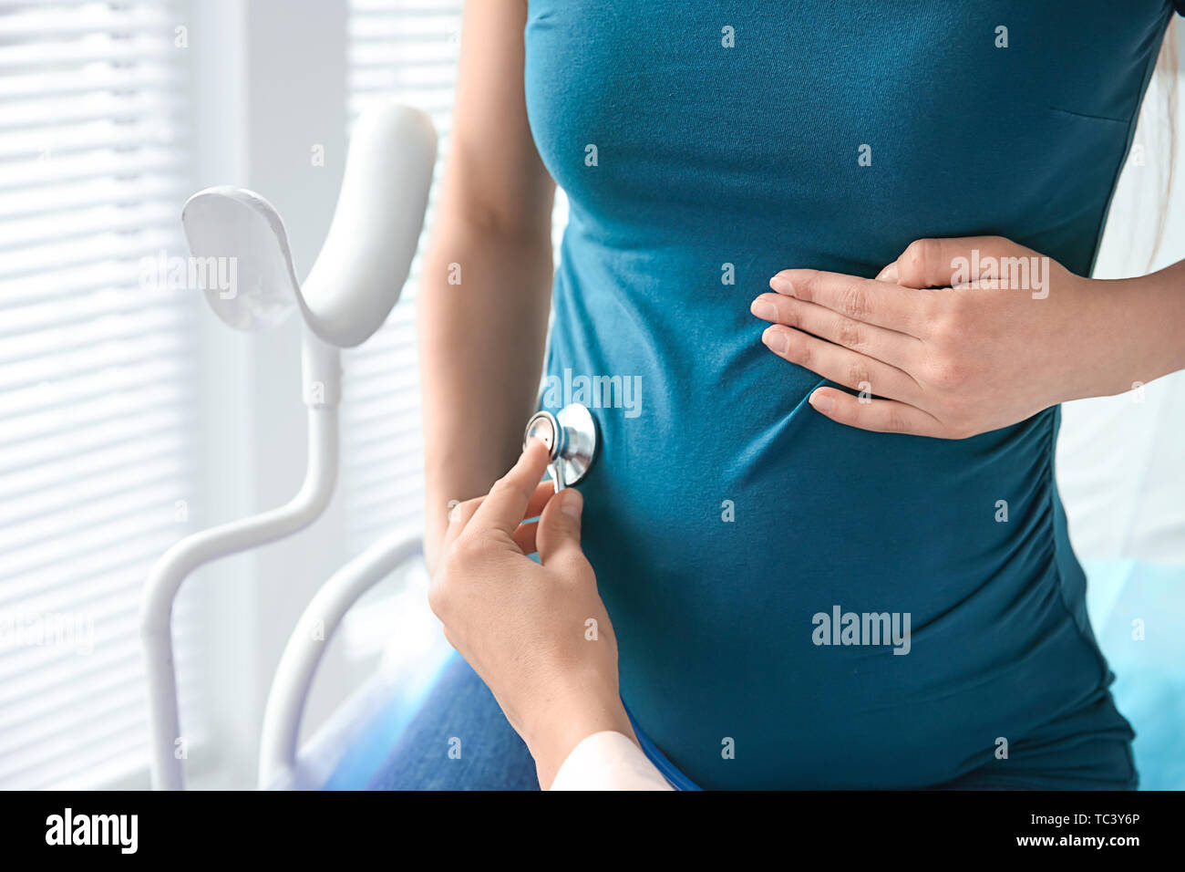 Female gynecologist working with pregnant woman in clinic Stock Photo ...