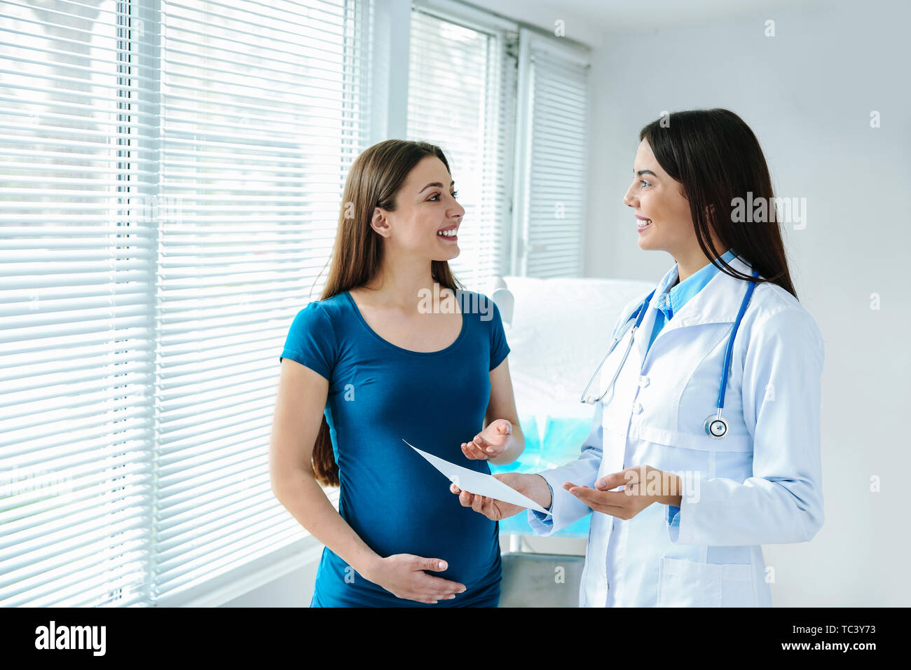 Female gynecologist working with pregnant woman in clinic Stock Photo ...