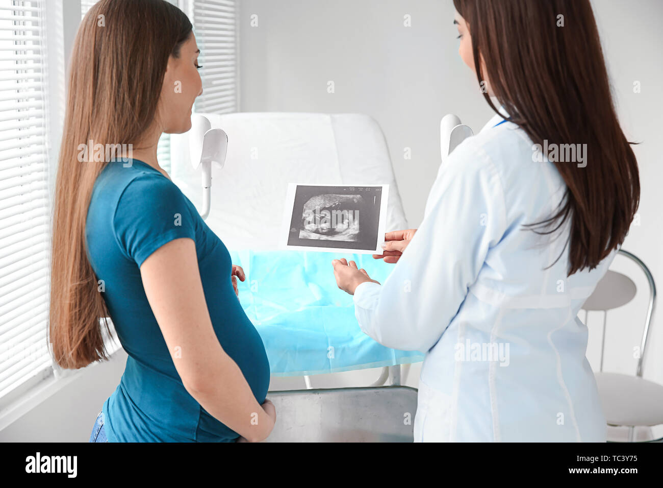 Female gynecologist working with pregnant woman in clinic Stock Photo ...