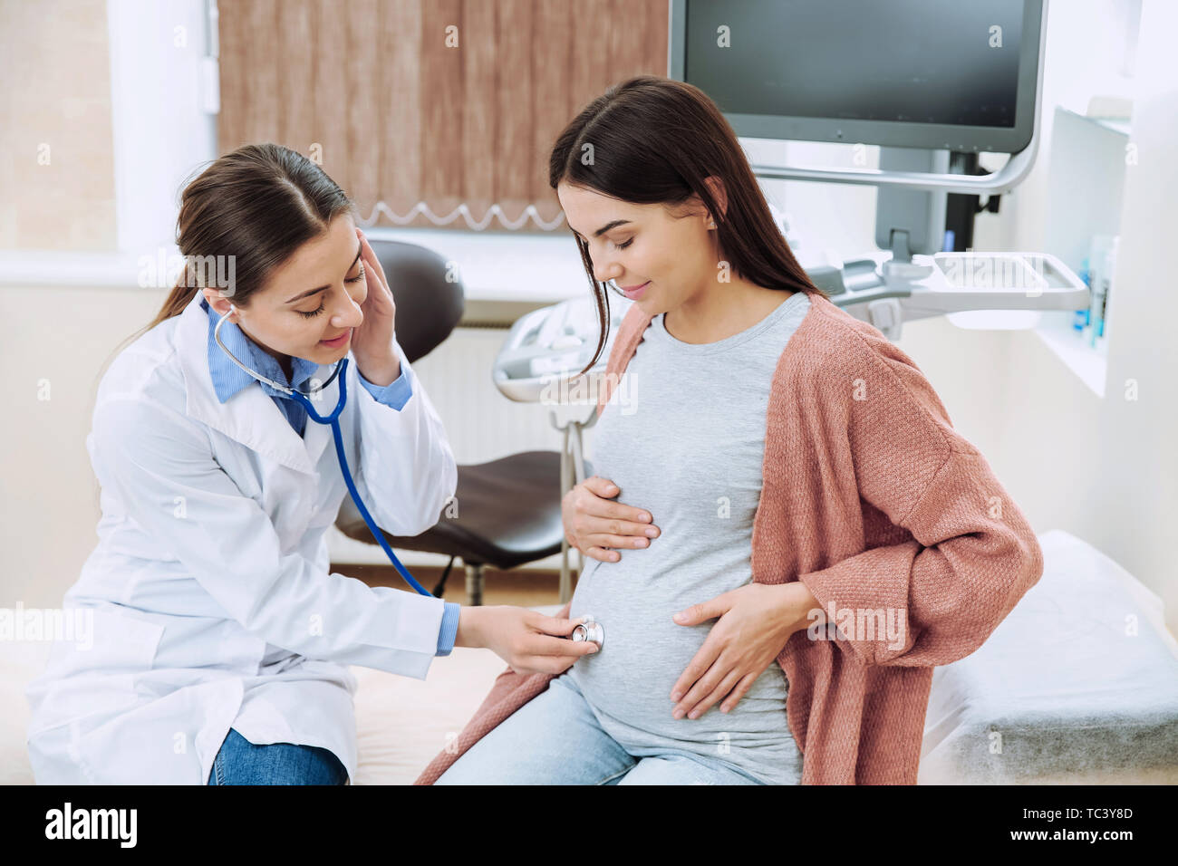 Female gynecologist working with pregnant woman in clinic Stock Photo ...
