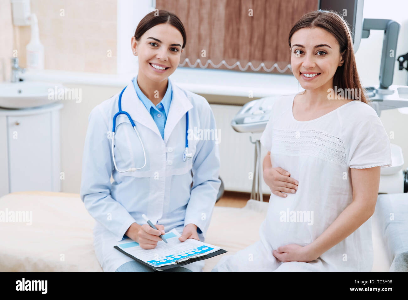 Female gynecologist working with pregnant woman in clinic Stock Photo ...