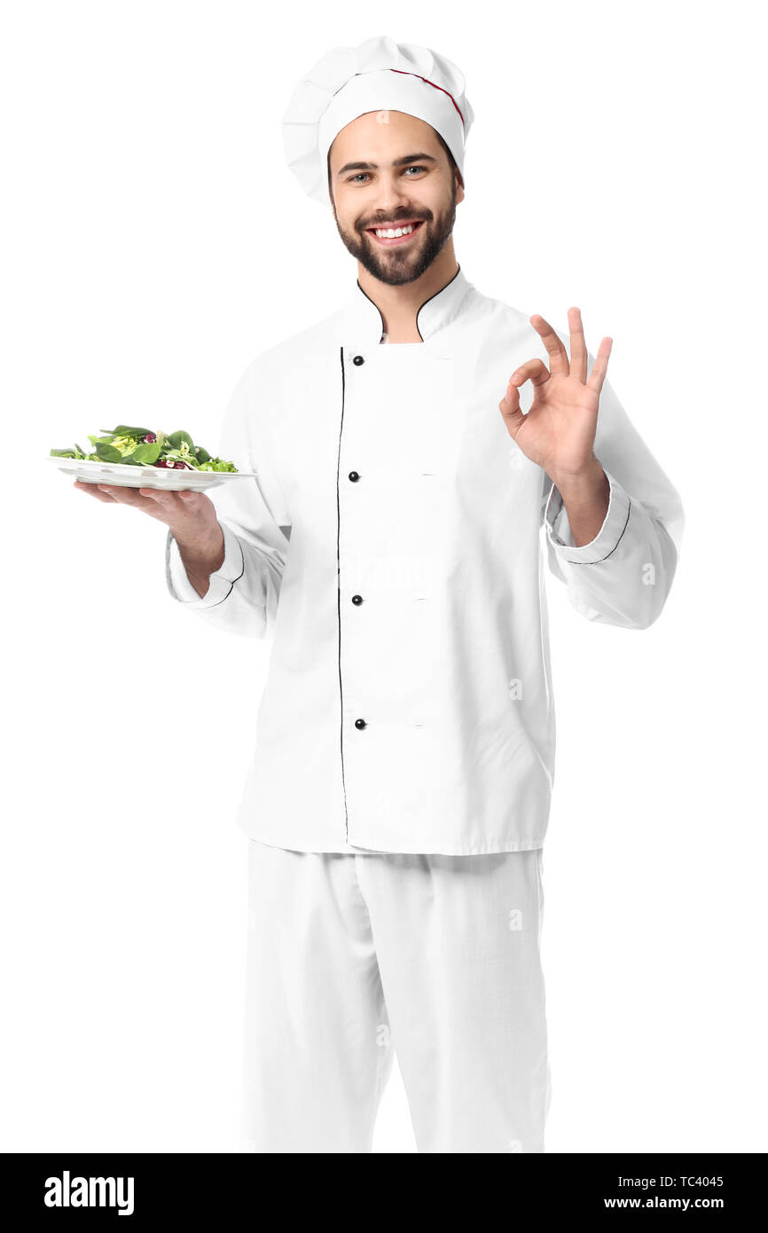 Handsome male chef with salad on white background Stock Photo - Alamy