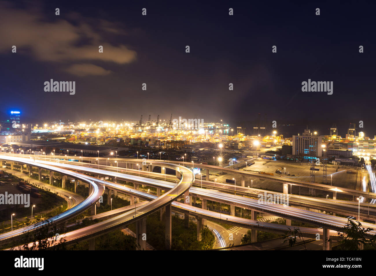 Illuminated and elevated expressway and cityscape at night Stock Photo ...