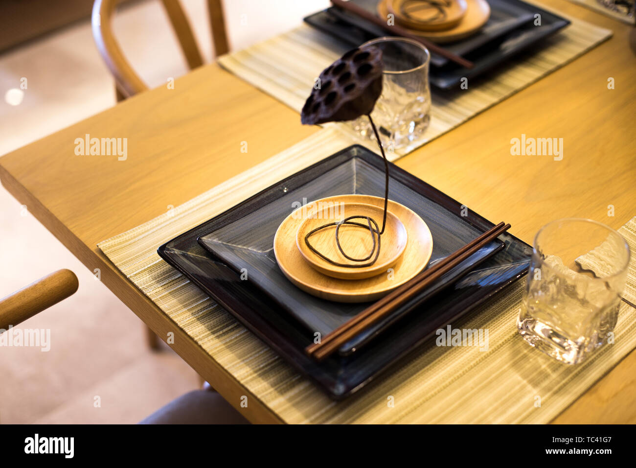 elegant crockery on wood table in modern dining room Stock Photo - Alamy