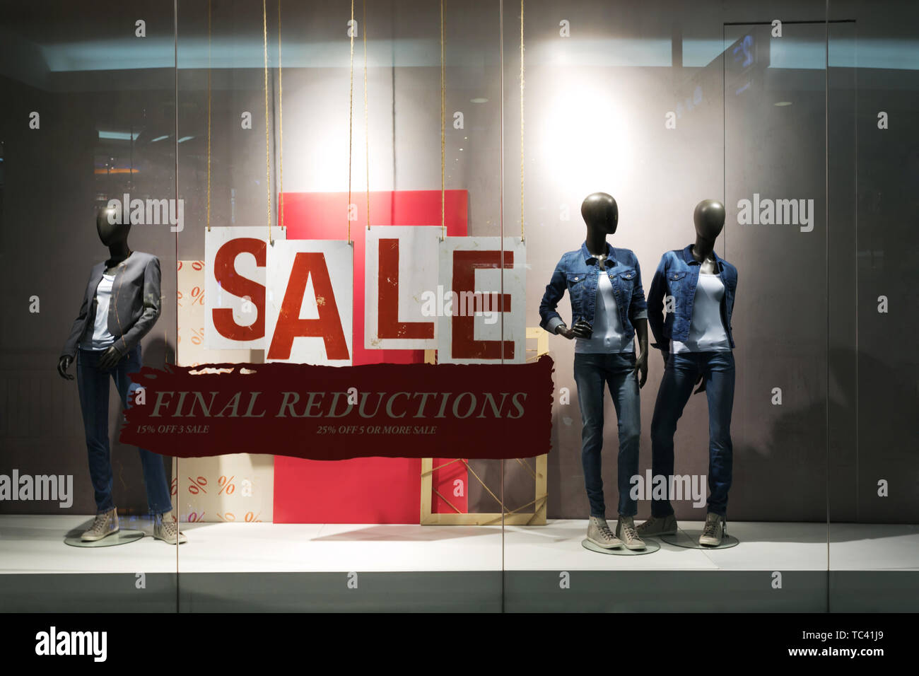 clothes storefront window with sale poster Stock Photo - Alamy