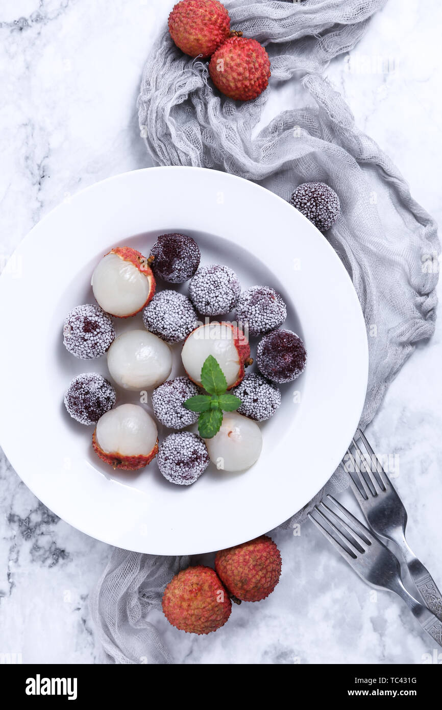 Frozen plum and fresh lychee Stock Photo - Alamy