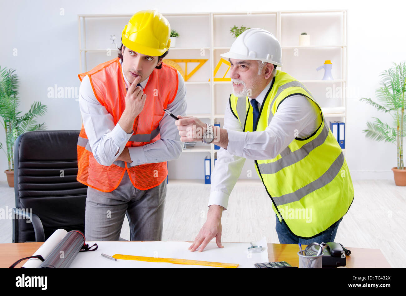 Two engineers colleagues working under project Stock Photo - Alamy