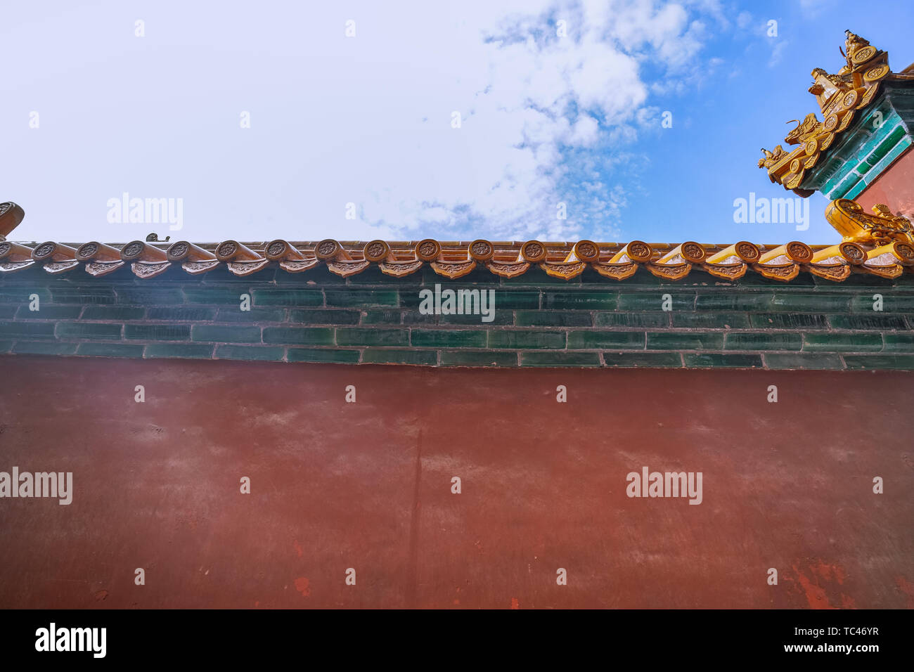 Red palace wall with yellow glazed tile Stock Photo - Alamy