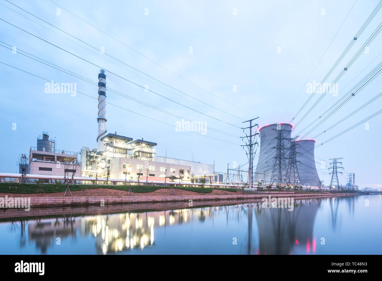 modern factory near river in blue sky at dawn Stock Photo - Alamy