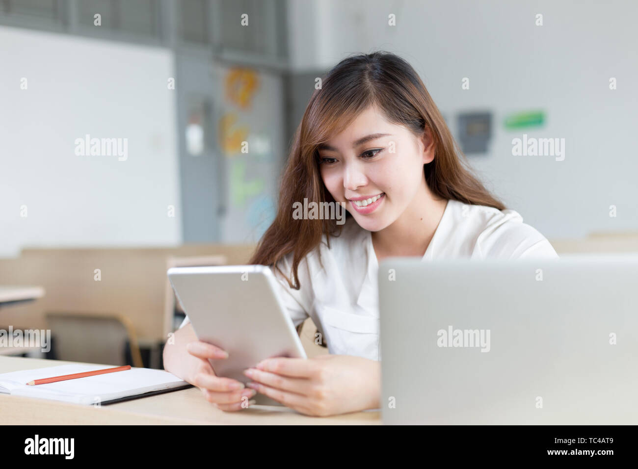 Asian beautiful female student study with tablet in classroom Stock ...
