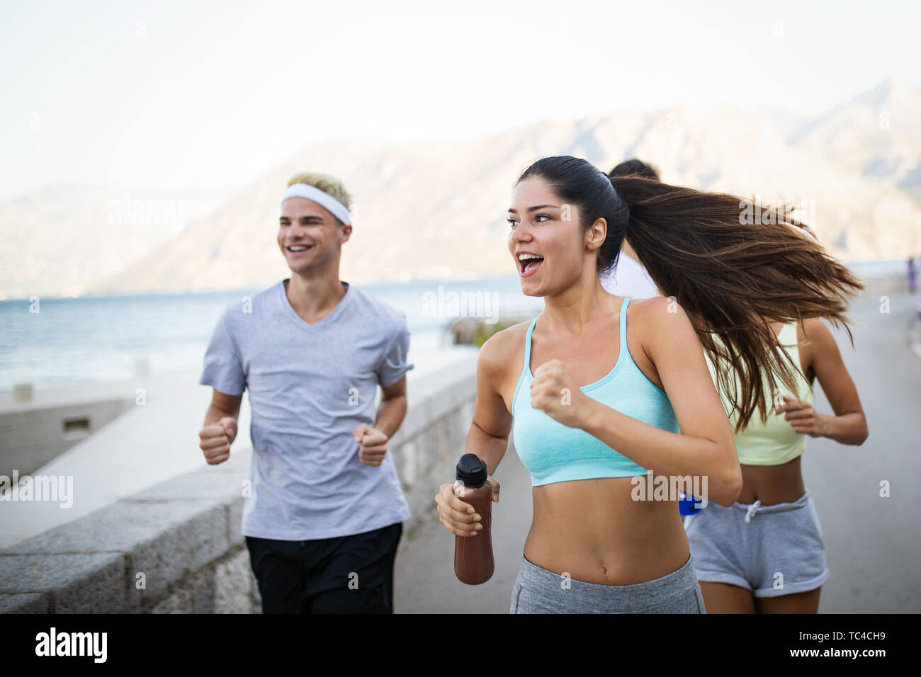 Group of young people friends running outdoors at seaside Stock Photo ...