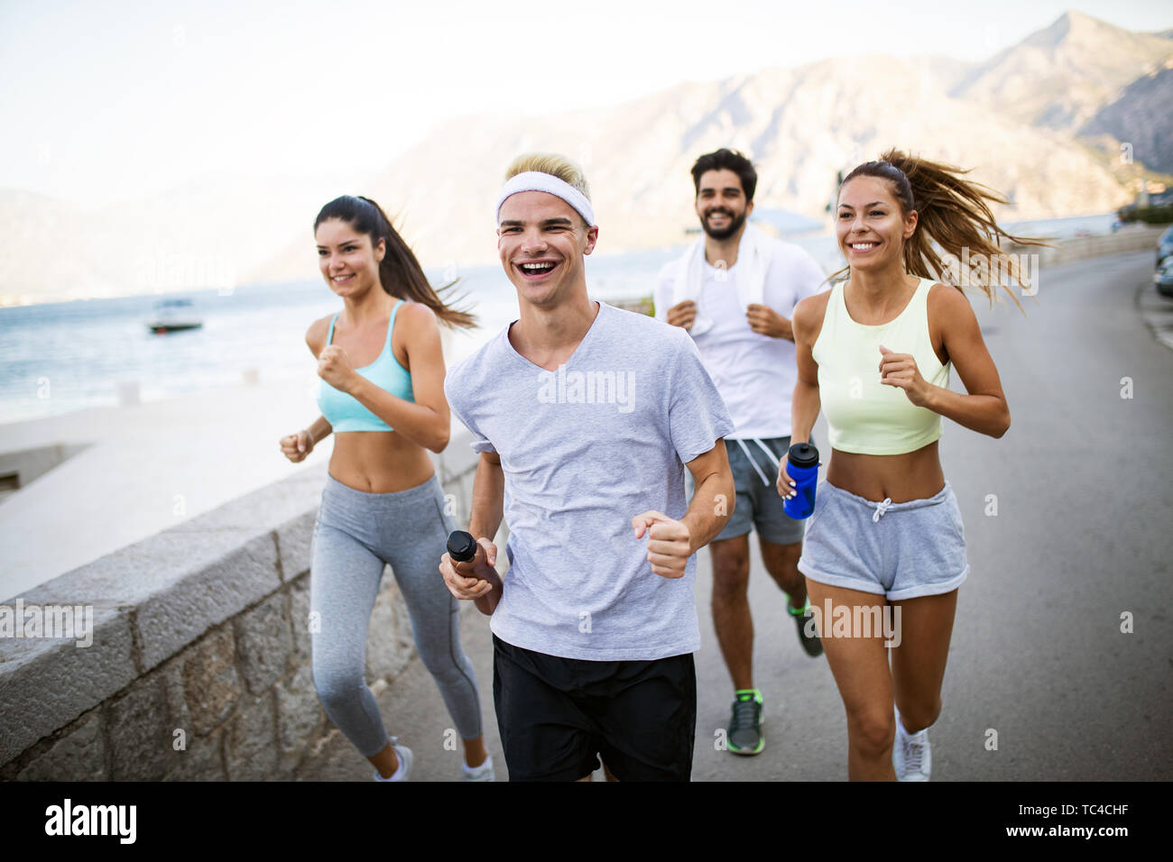 Group of young people friends running outdoors at seaside Stock Photo ...