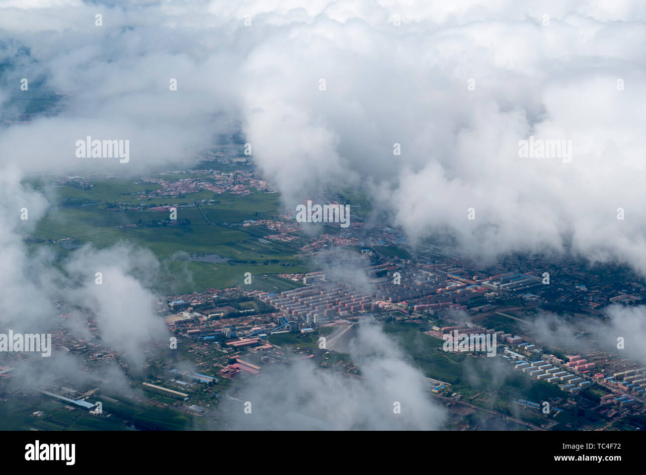 Aerial shot of mountains, fields, villages, towns under the blue sky ...