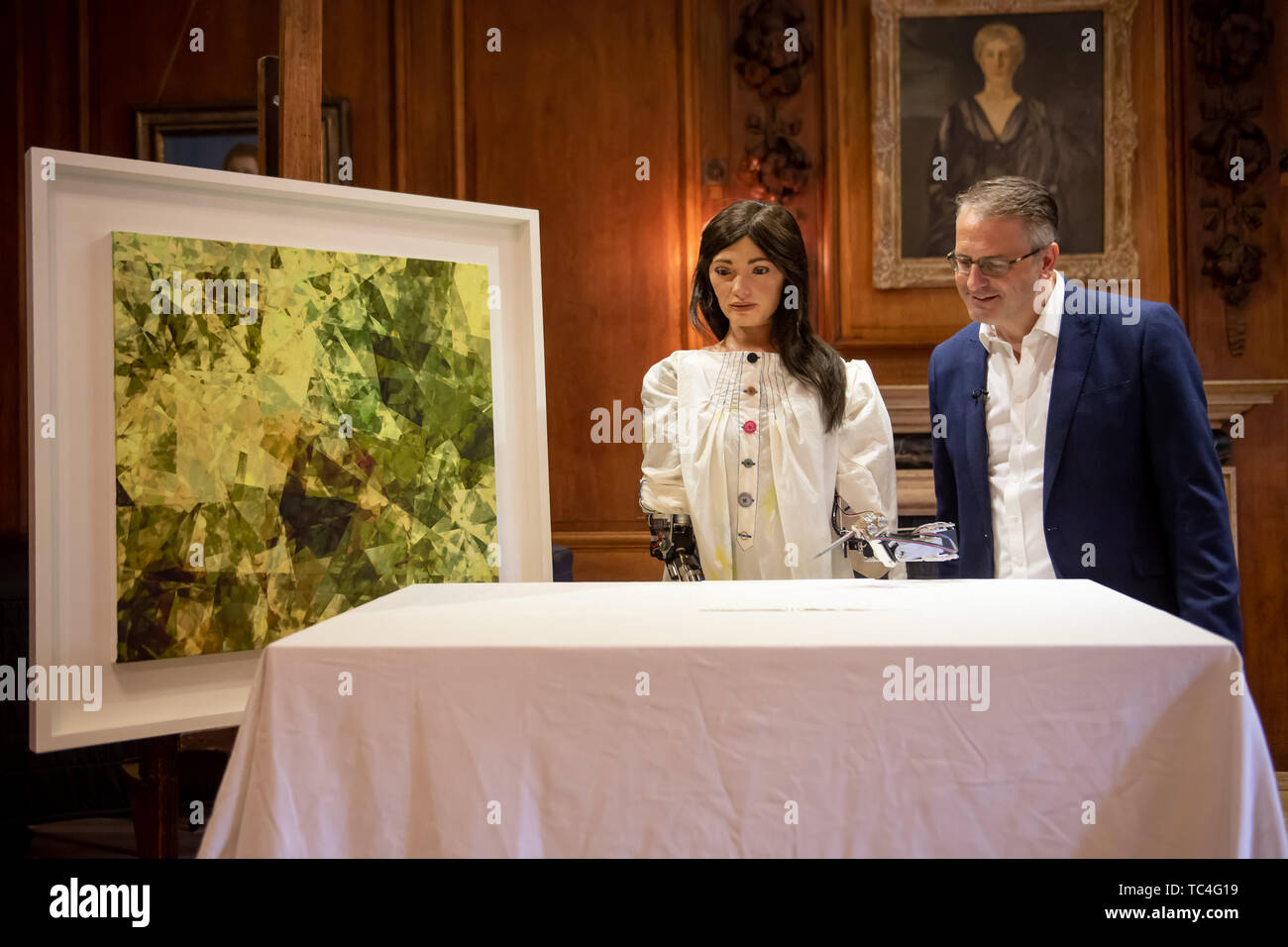 Creator Aidan Meller looks at a drawing being created by Ai-Da at a ...