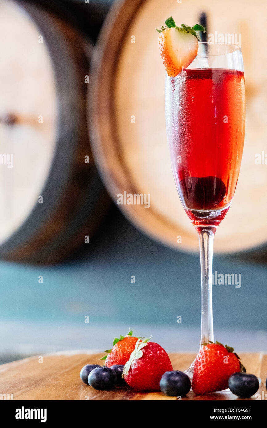 close up of a colorful fancy trendy cocktail garnished with fresh ...