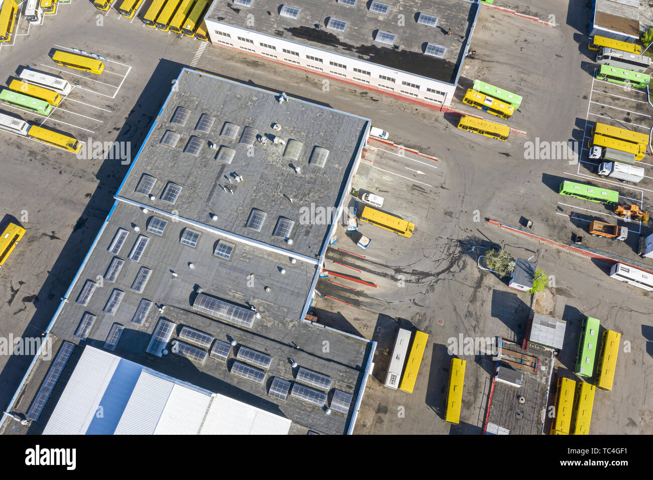 buses parked in rows at bus depot near garage buildings. top view Stock ...