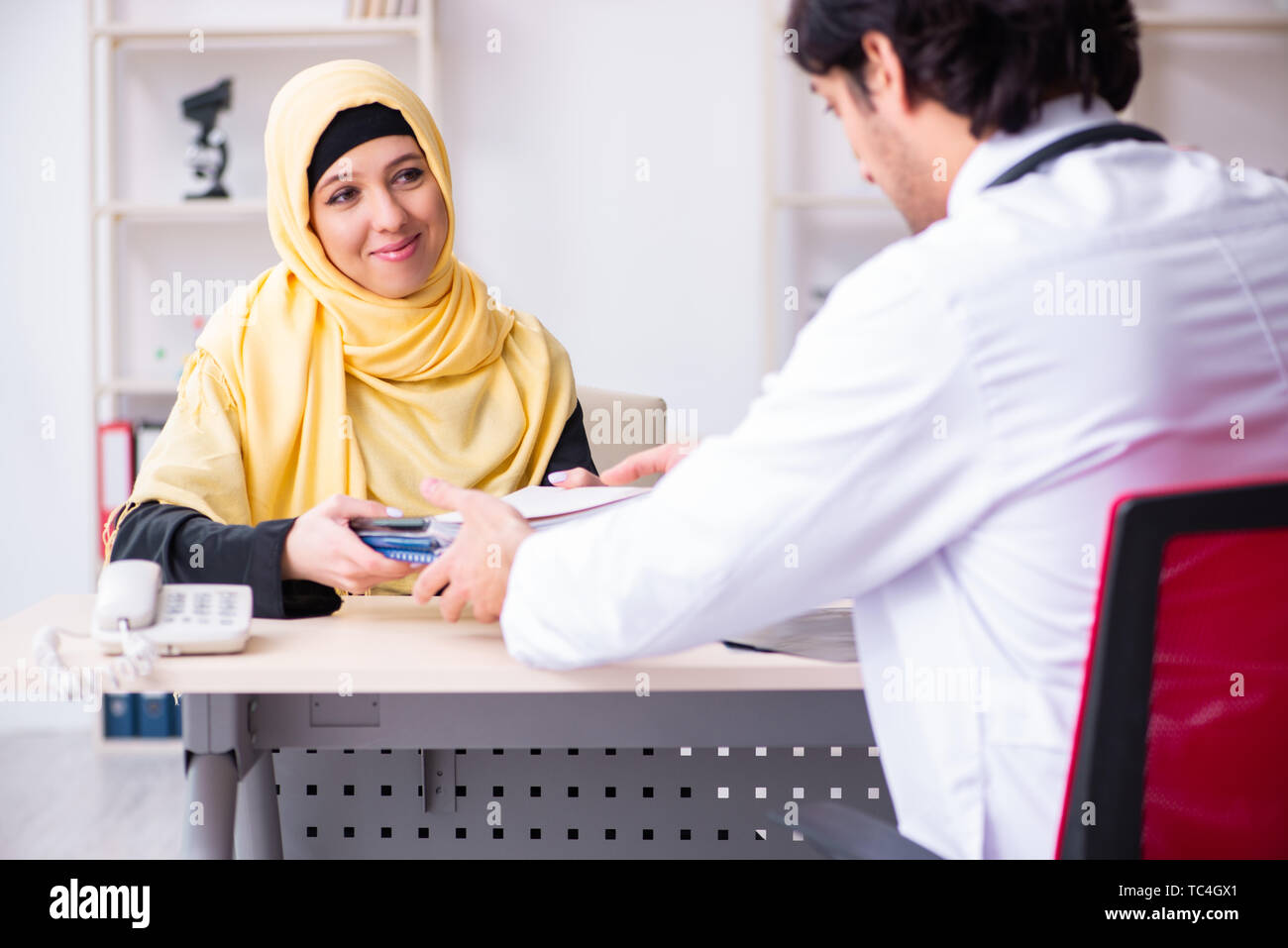 Female arab patient visiting male doctor Stock Photo - Alamy
