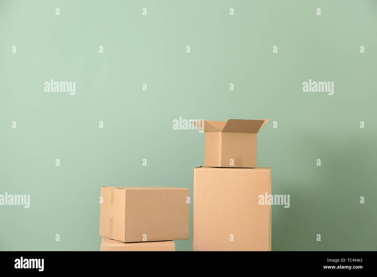 Cardboard boxes on color background Stock Photo - Alamy