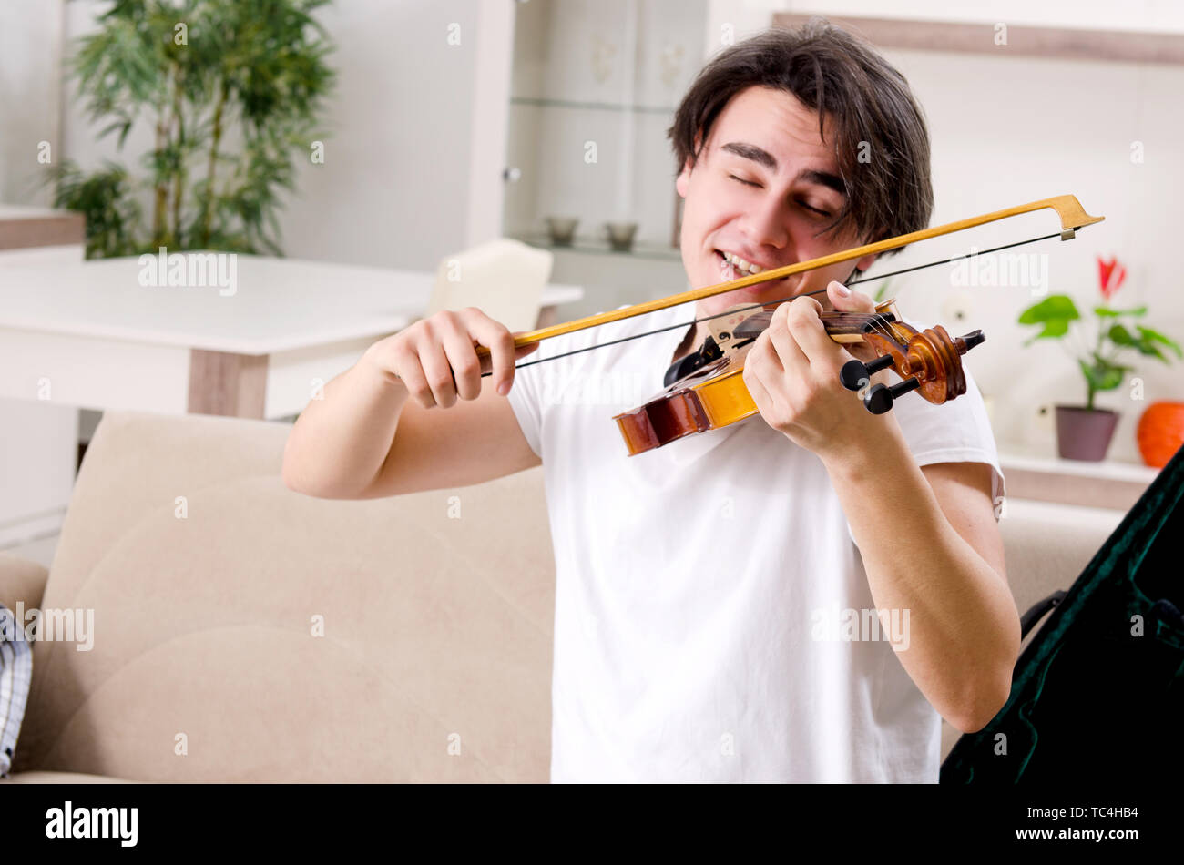Young musician man practicing playing violin at home Stock Photo - Alamy