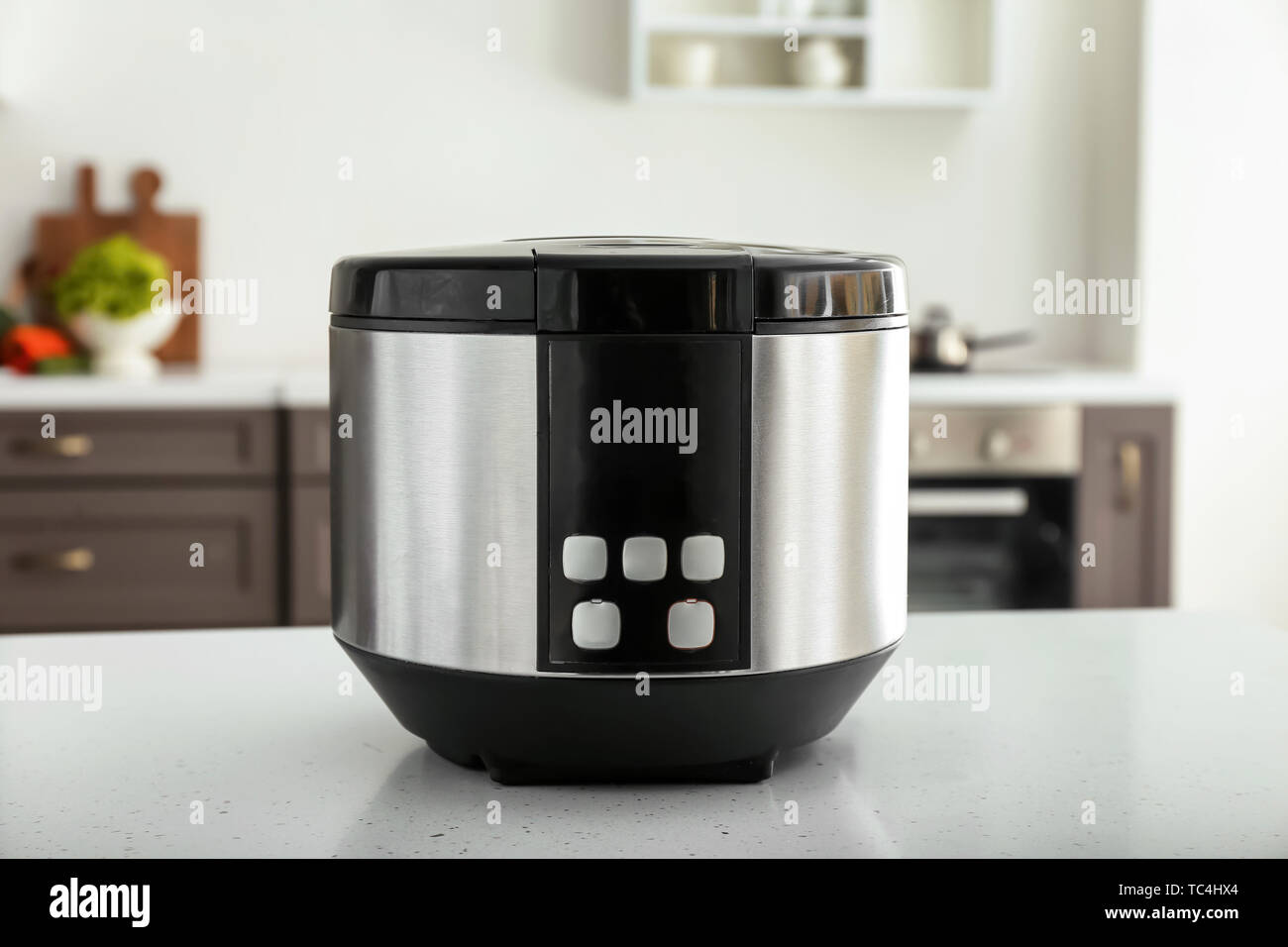Modern multi cooker on table in kitchen Stock Photo - Alamy