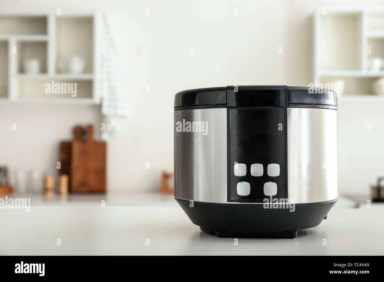 Modern multi cooker on table in kitchen Stock Photo - Alamy