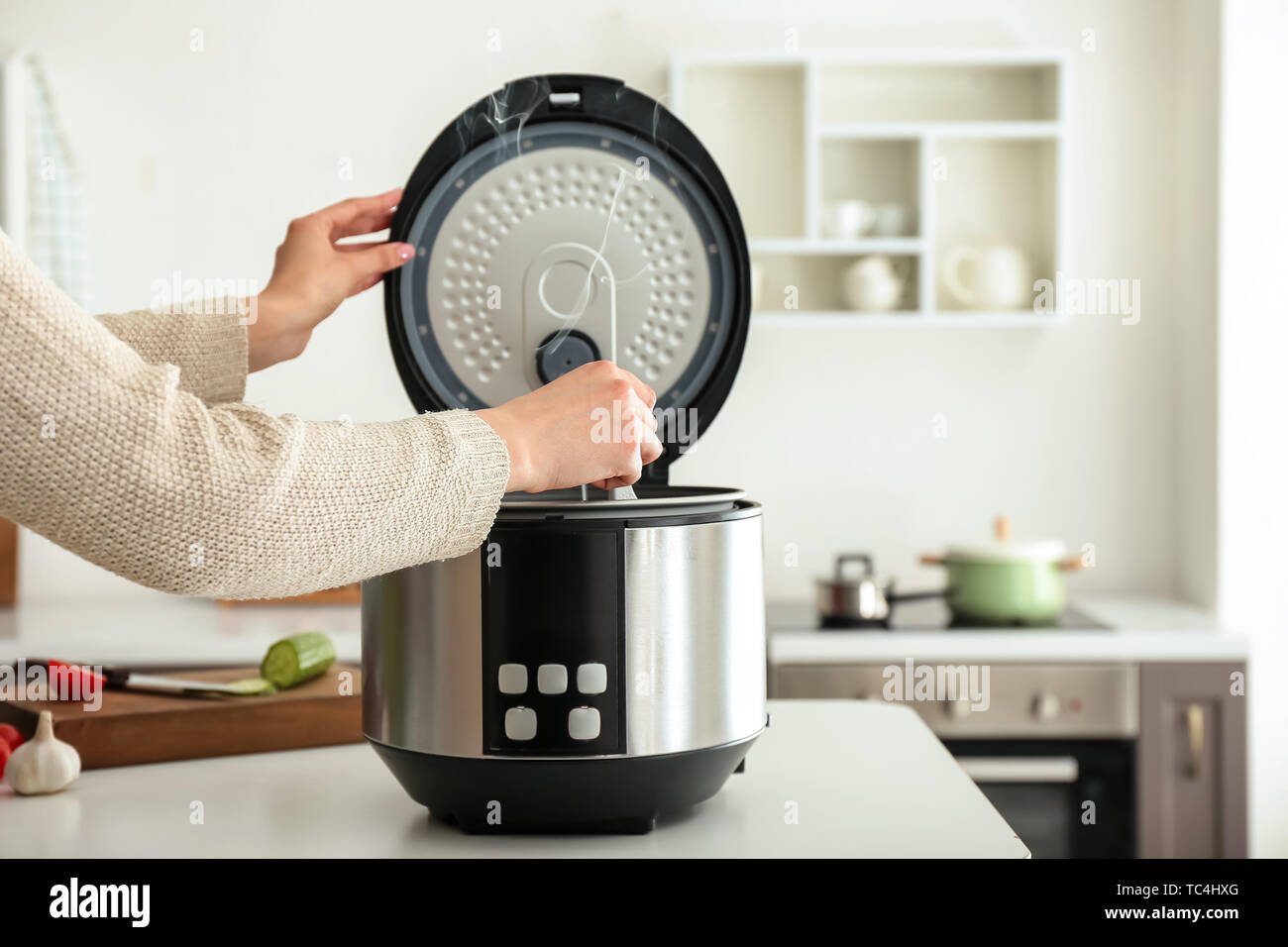 Woman cooking food in multi cooker at home Stock Photo - Alamy