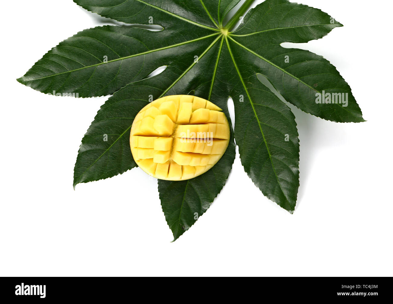 Tasty fresh mango with tropical leaf on white background Stock Photo ...