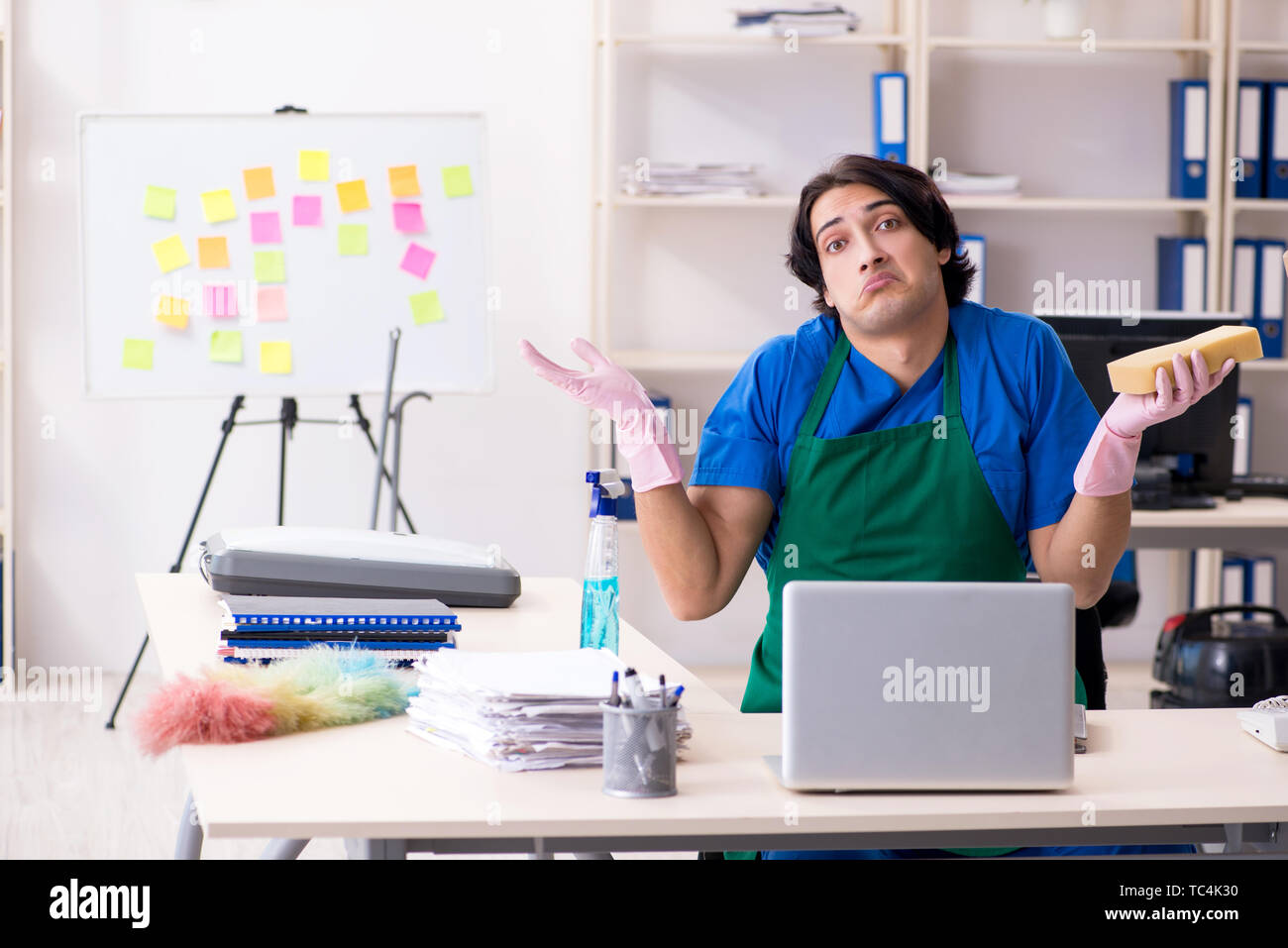 Male handsome professional cleaner working in the office Stock Photo ...