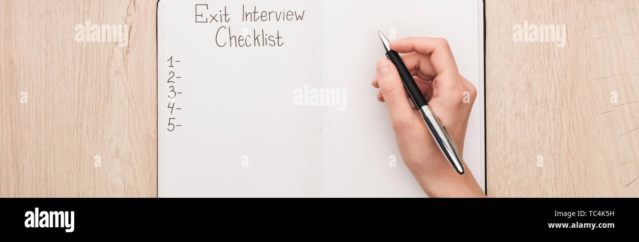 panoramic shot of recruiter writing in notebook with exit interview ...
