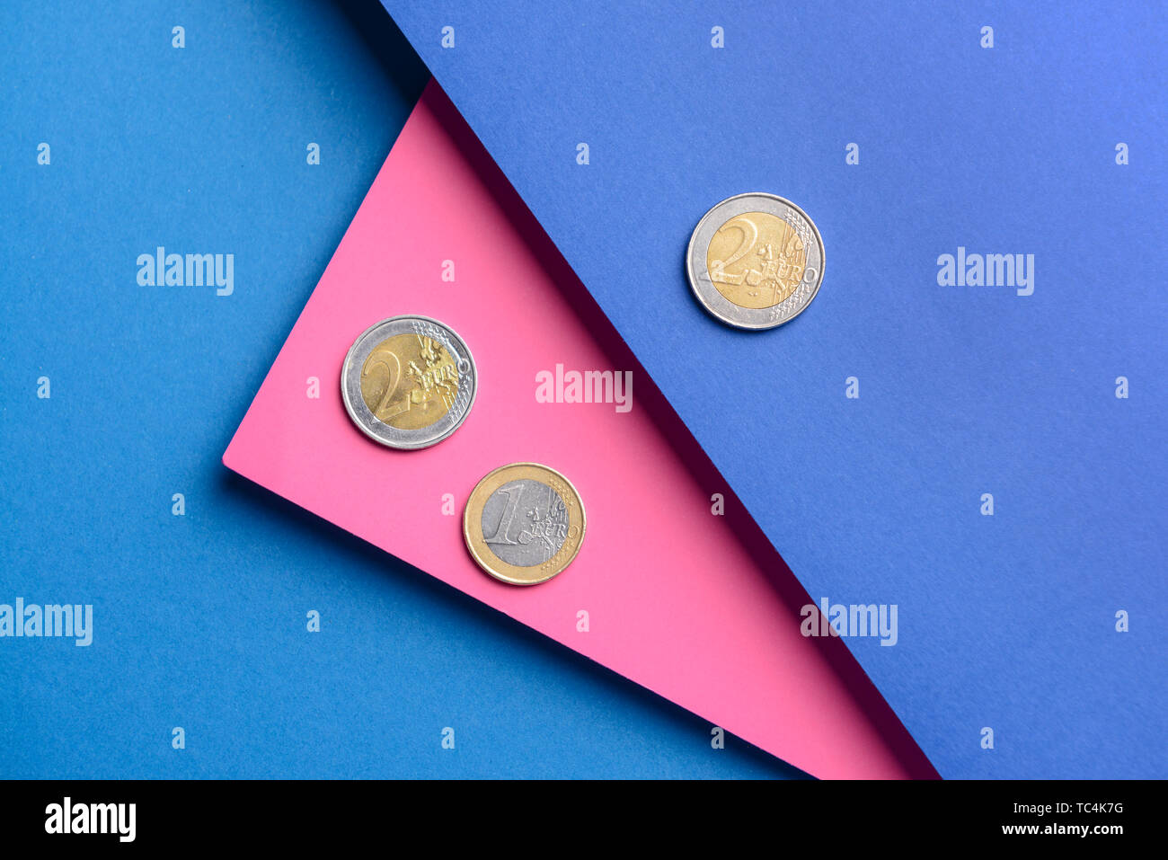 Paper sheets with coins on color background Stock Photo - Alamy