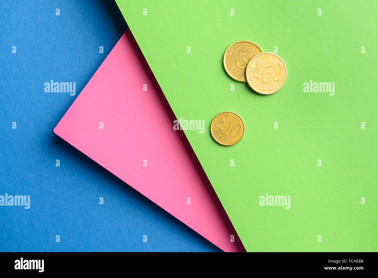 Paper sheets with coins on color background Stock Photo - Alamy