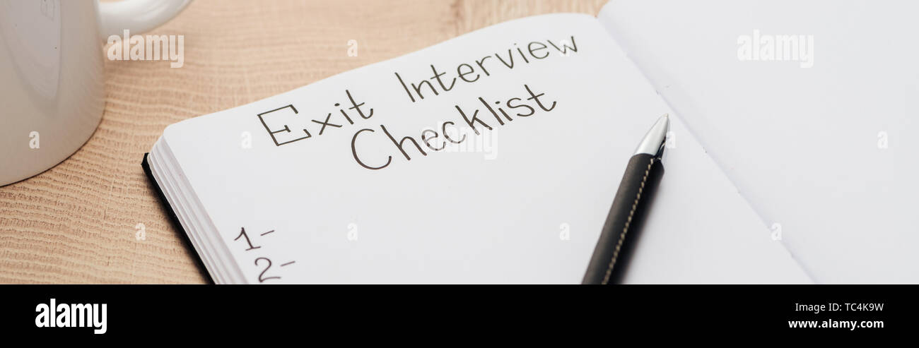 panoramic shot of notebook with exit interview checklist lettering and ...
