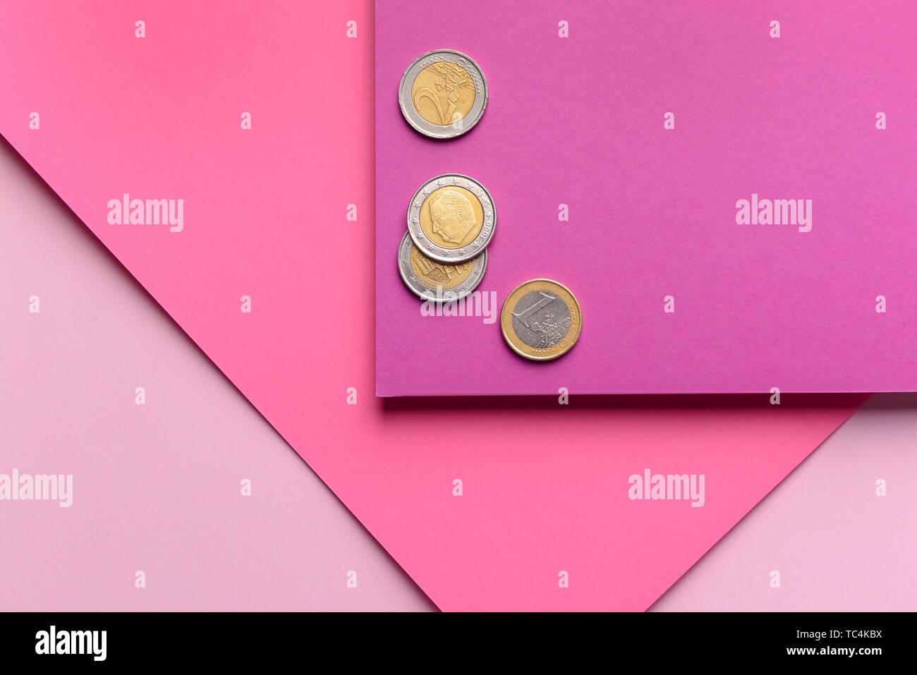 Paper sheets with coins on color background Stock Photo - Alamy