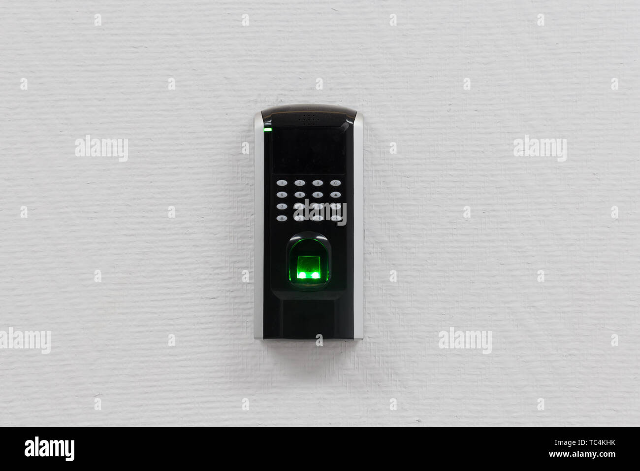 Fingerprint scanner on wall Stock Photo - Alamy