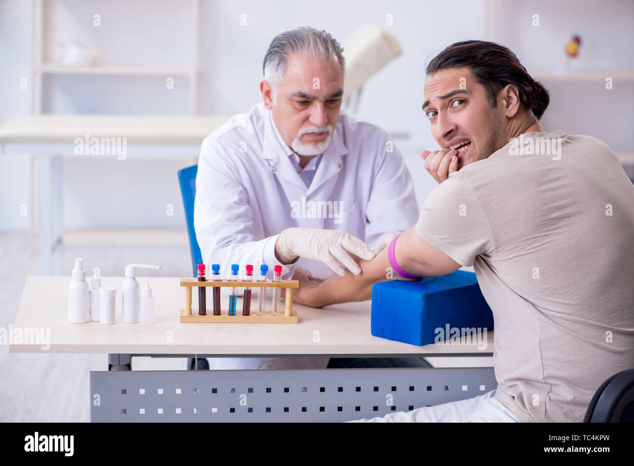 Young man giving sample hi-res stock photography and images - Alamy