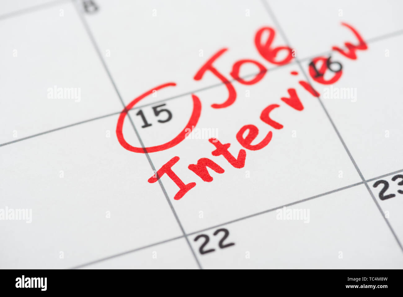 close up view of print calendar with red mark and job interview ...