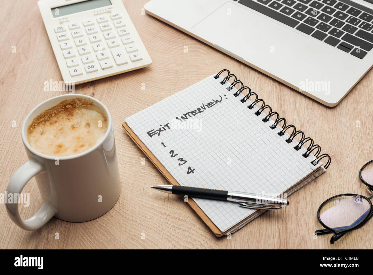 notebook with exit interview lettering and numbers on wooden table with ...