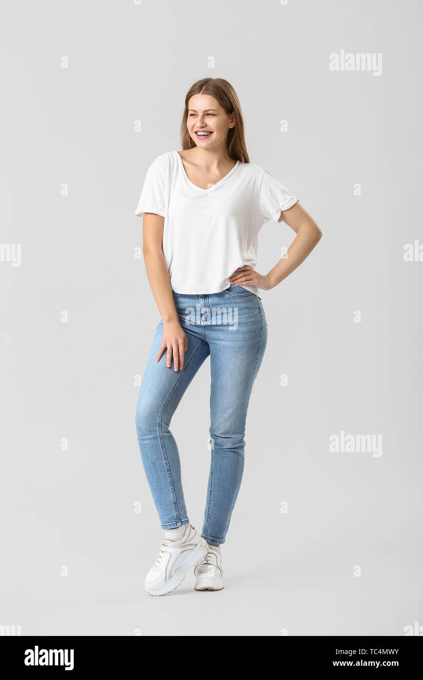 Beautiful young woman in jeans on white background Stock Photo - Alamy