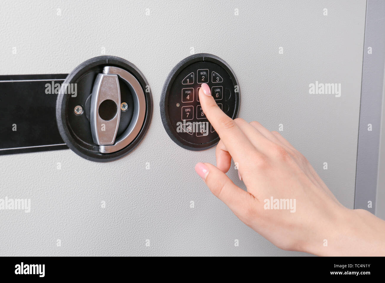 Woman opening metal safe hi-res stock photography and images - Alamy