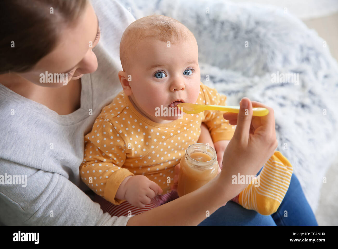 Mother feeding baby girl with puree hi-res stock photography and images ...