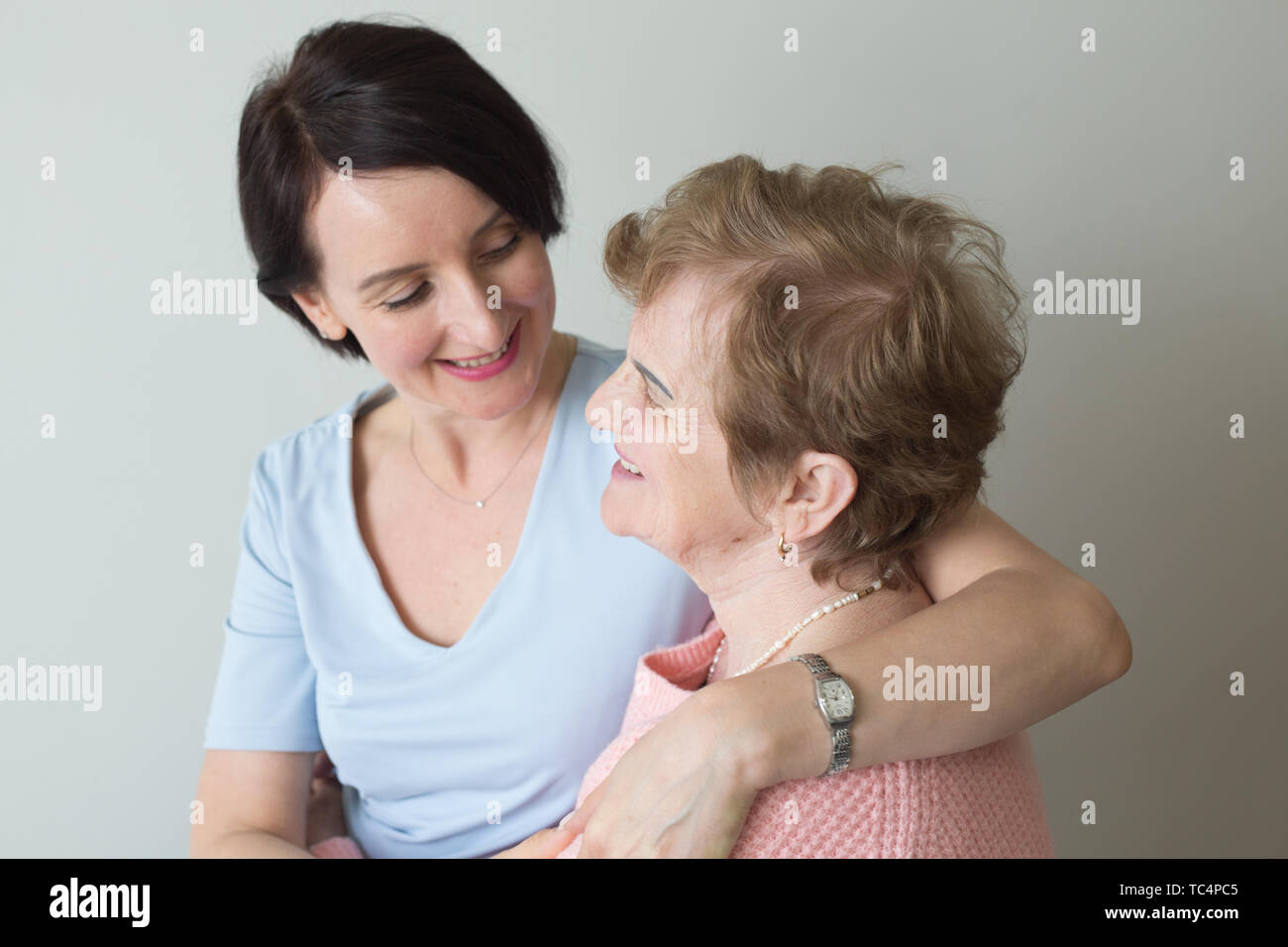 Adult daughter hugging elderly mother concept connection Stock Photo ...