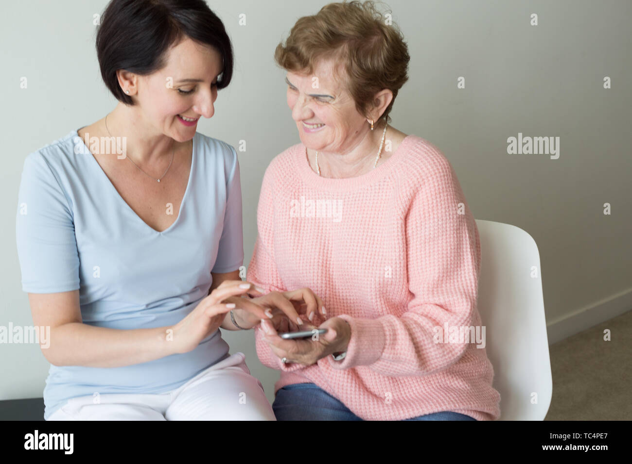 Child helping elderly hi-res stock photography and images - Alamy