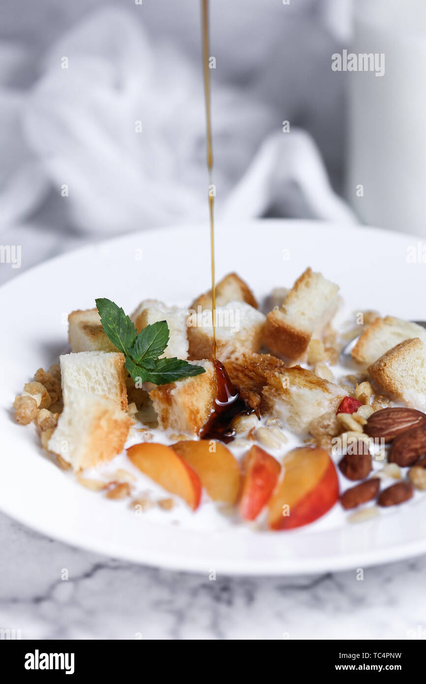 Milk toast, fruit nuts breakfast Stock Photo - Alamy